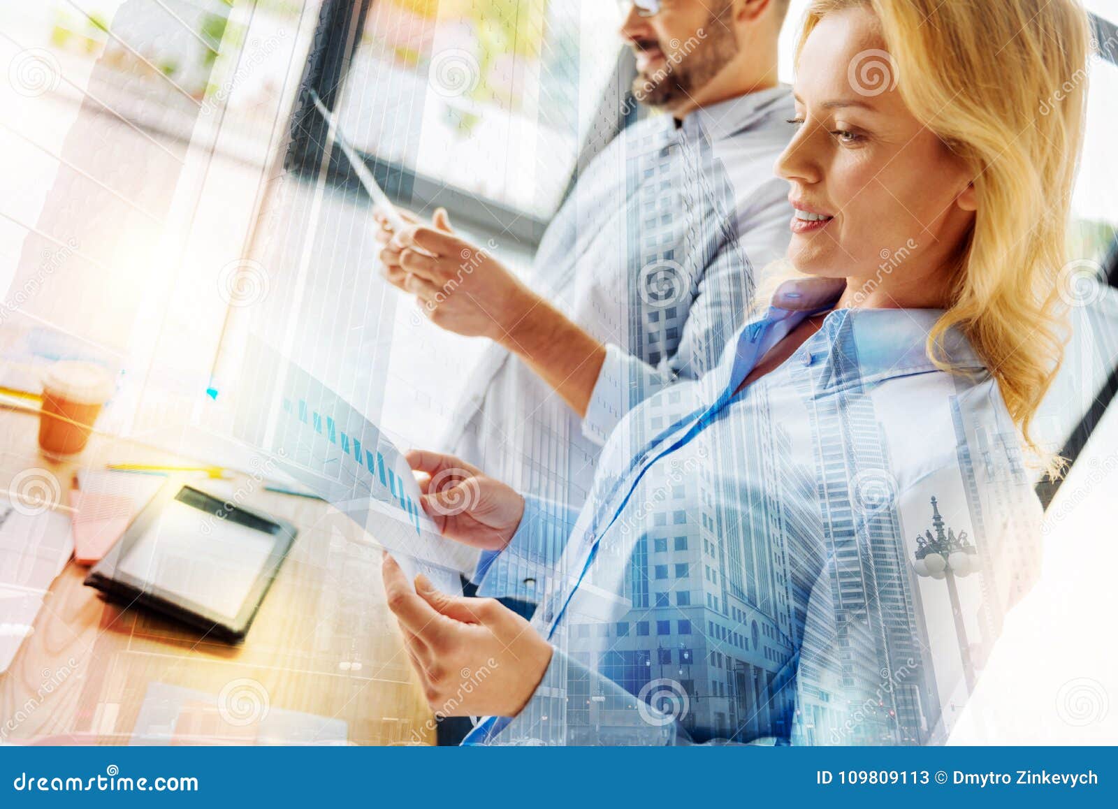 Young Specialist Smiling while Looking at the Statistics in Her Hands ...