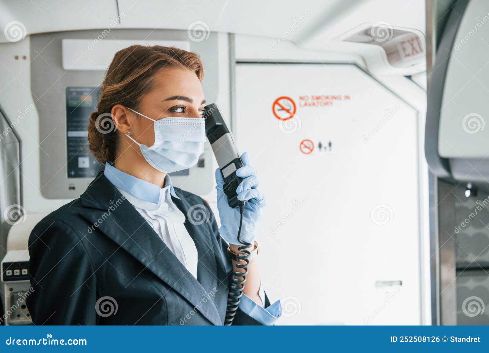 Uses Phone. Young Stewardess on the Work in the Passanger Airplane ...
