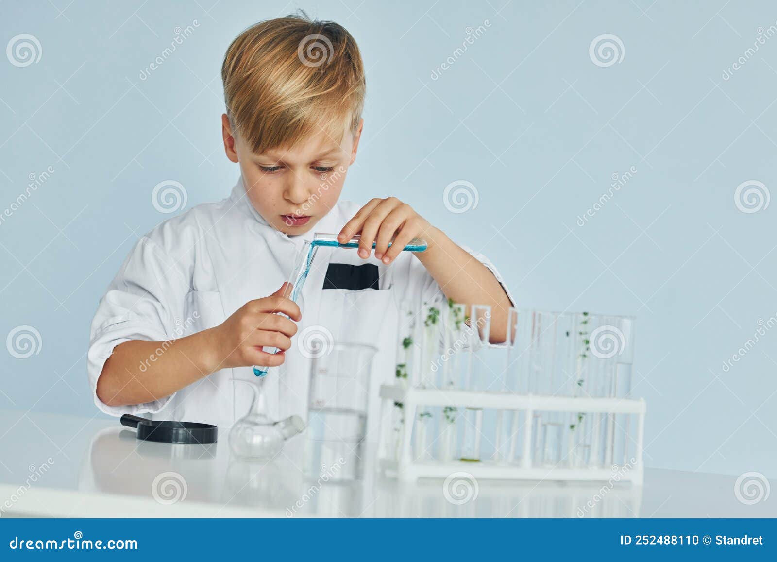 Uses Test Tubes. Little Boy in Coat Playing a Scientist in Lab by Using ...