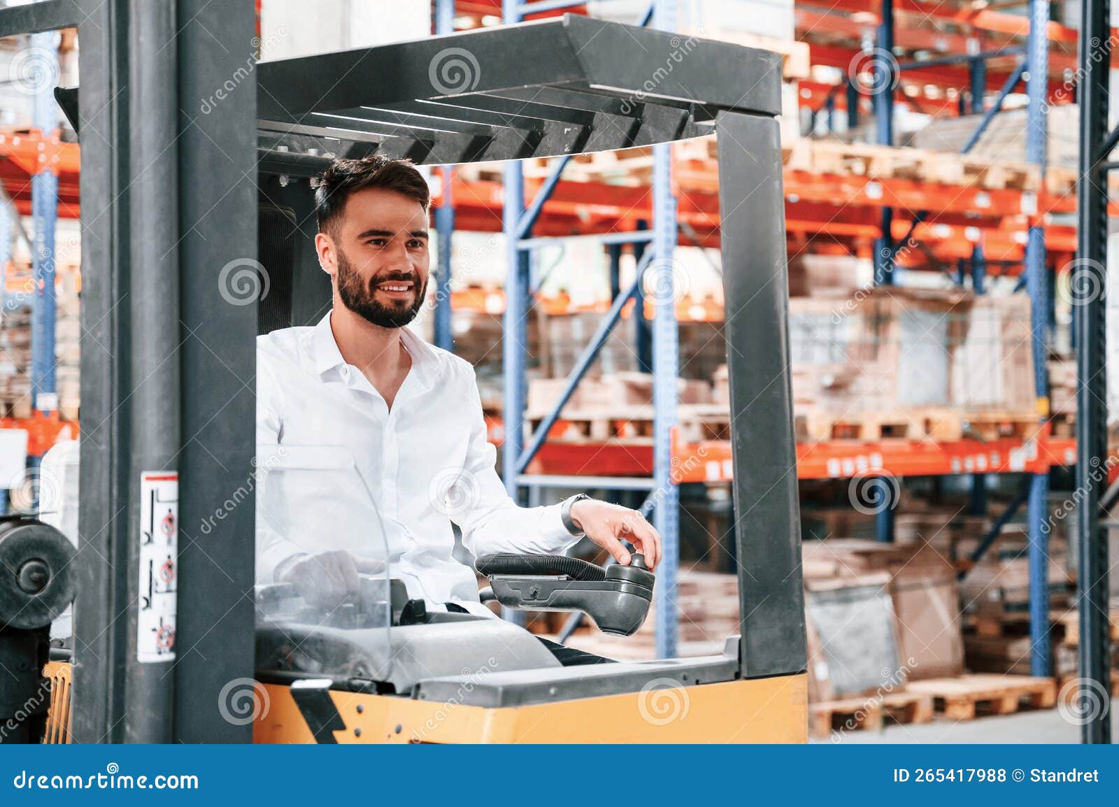 Using Cargo Moving Machine. Storage Worker is in the Warehouse with ...