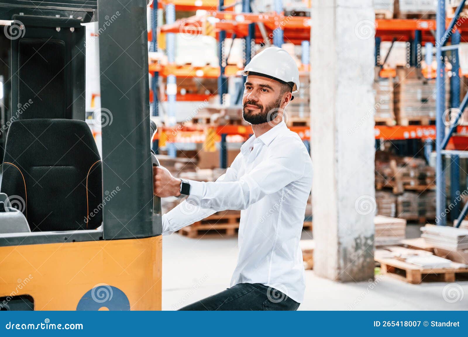 Using Cargo Moving Machine. Storage Worker is in the Warehouse with ...