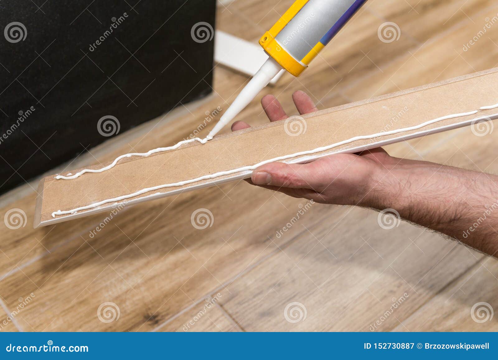 Using Caulking Gun To Install White Skirting Board Stock Image - Image ...