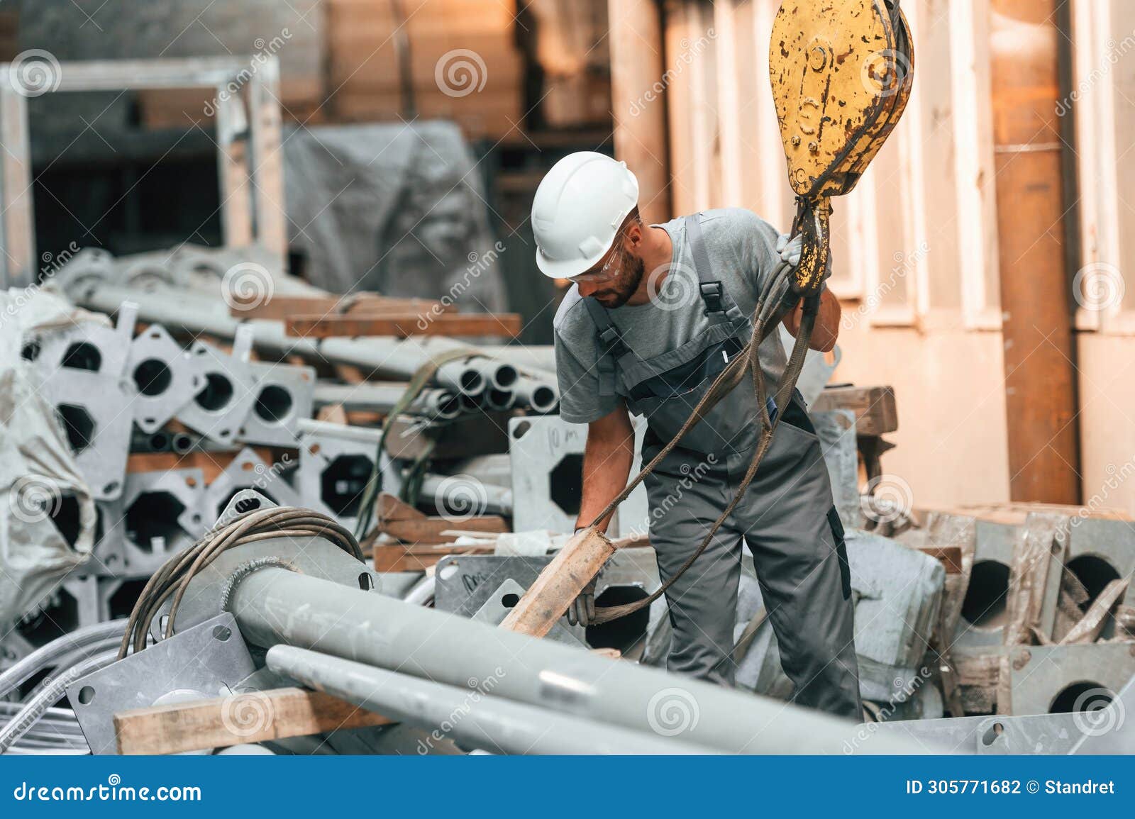 Using Crane Hook. Young Factory Worker in Grey Uniform Stock Photo ...