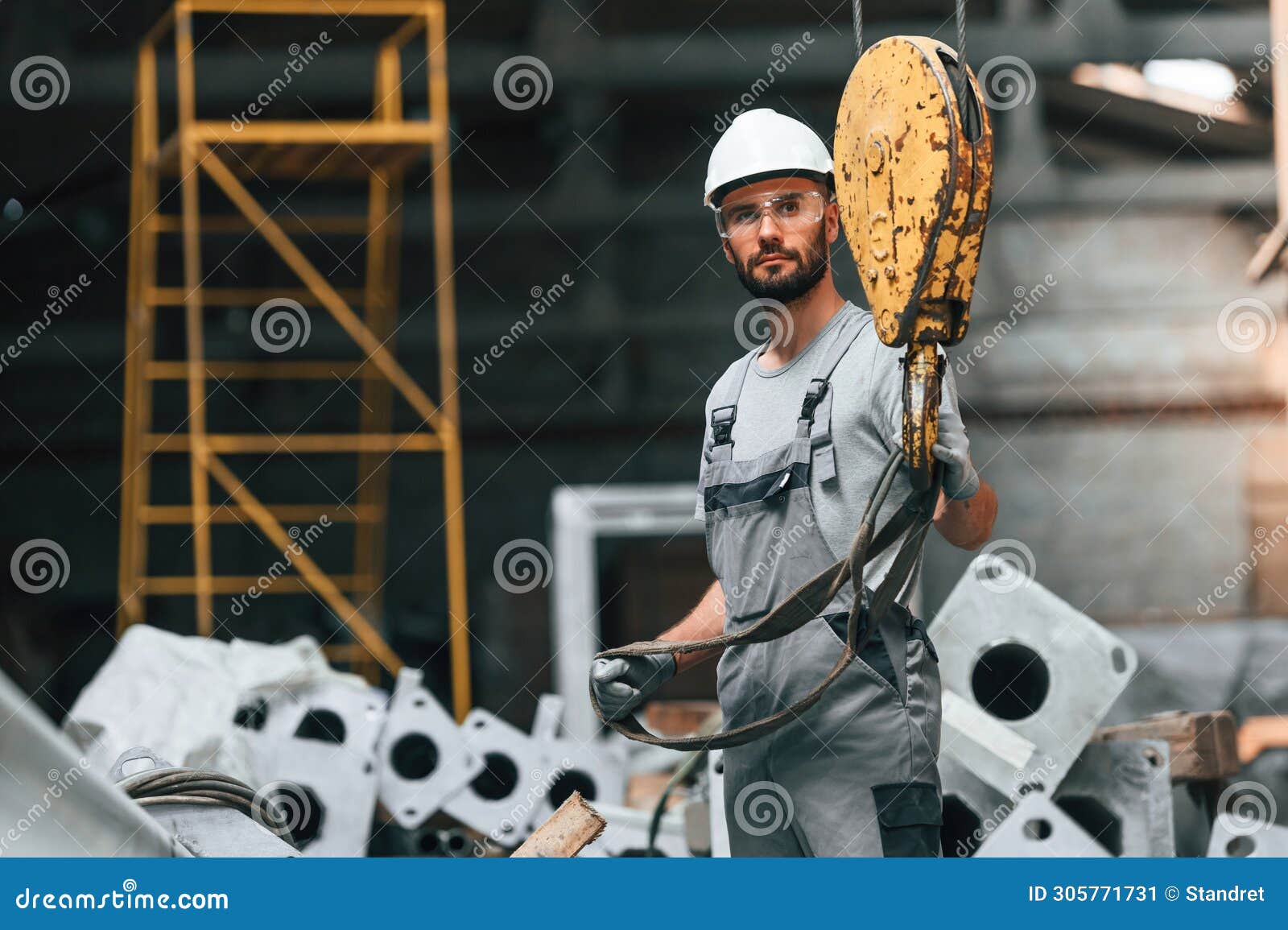 Using Crane Hook. Young Factory Worker in Grey Uniform Stock Image ...