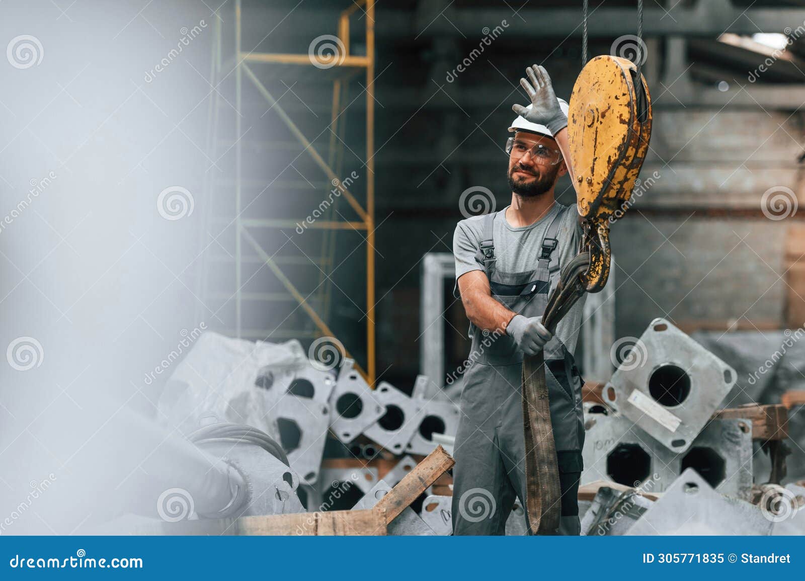 Using Crane Hook. Young Factory Worker in Grey Uniform Stock Image ...