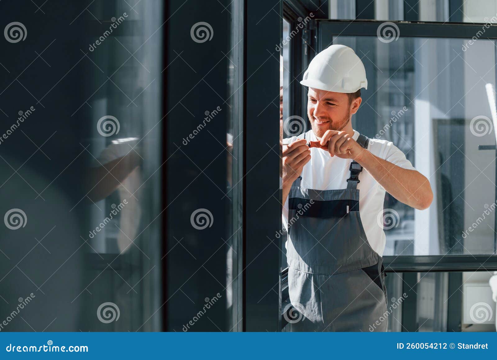 Using Drill by Installing Windows. Repairman is Working Indoors in the ...