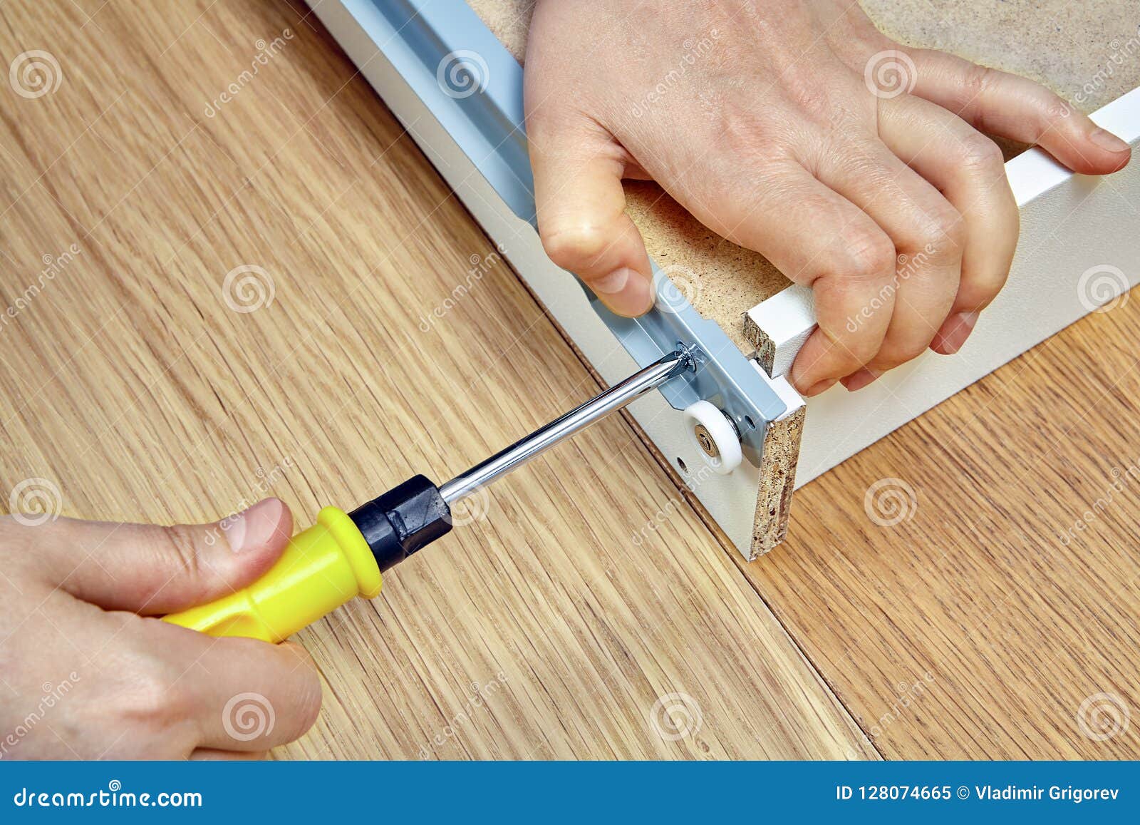 Using Furniture Fasteners And Screwdriver When Mounting A Drawer Stock