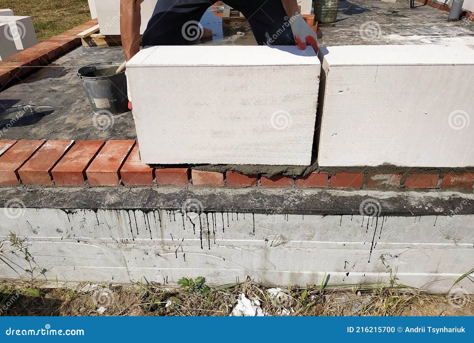 Using a Glue Solution, the Worker Begins To Build a Wall of Gas Blocks ...