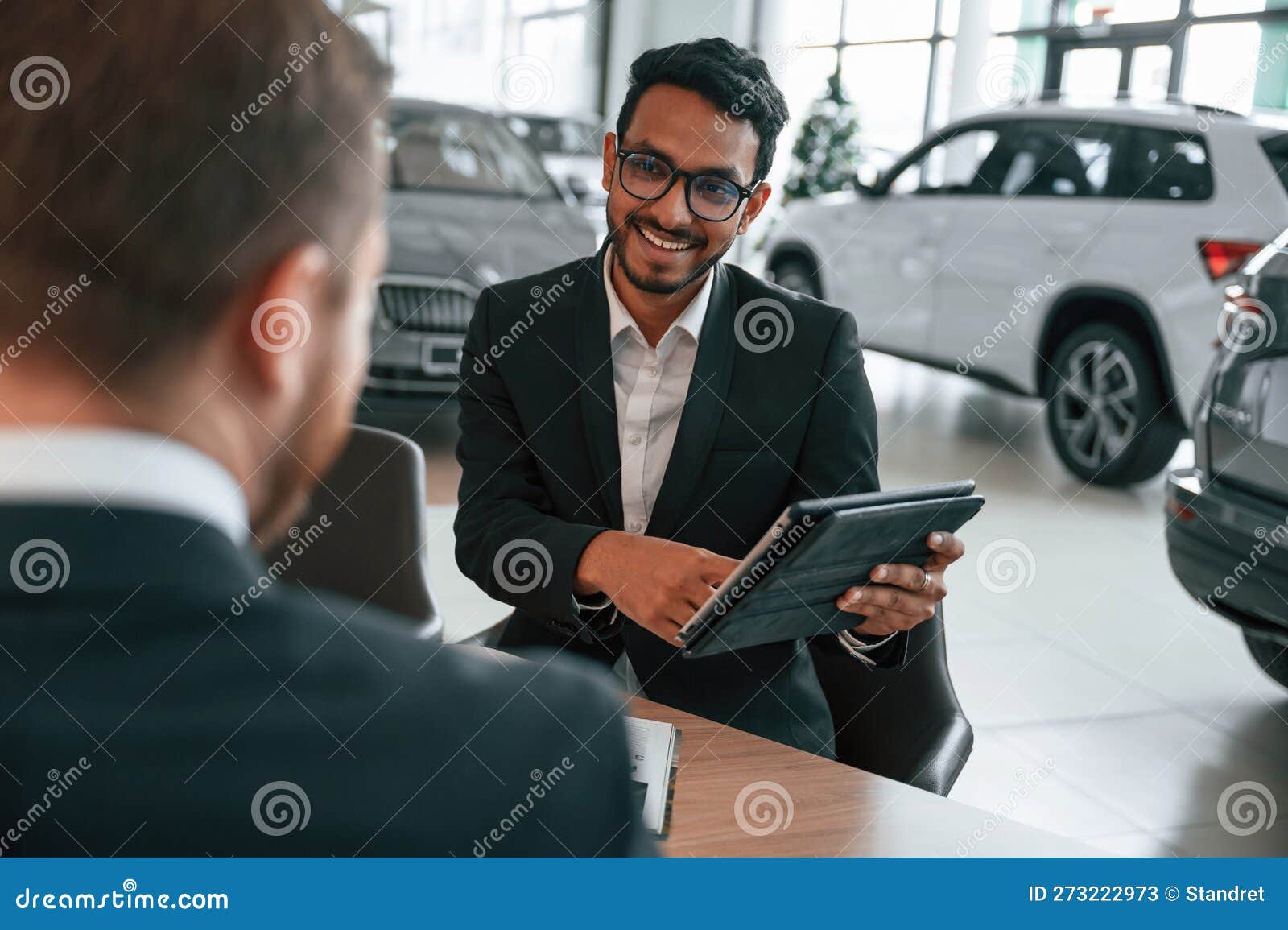 Using Graphic Tablet. Man is Consulting the Customer in the Car ...