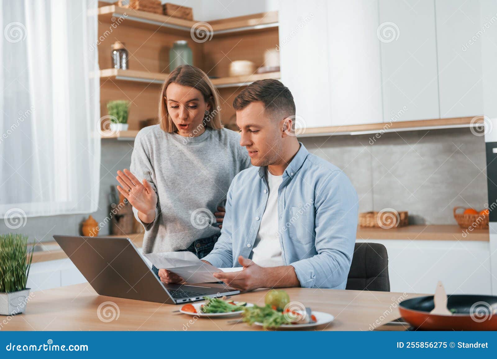 Using Internet. Couple Preparing Food at Home on the Modern Kitchen ...