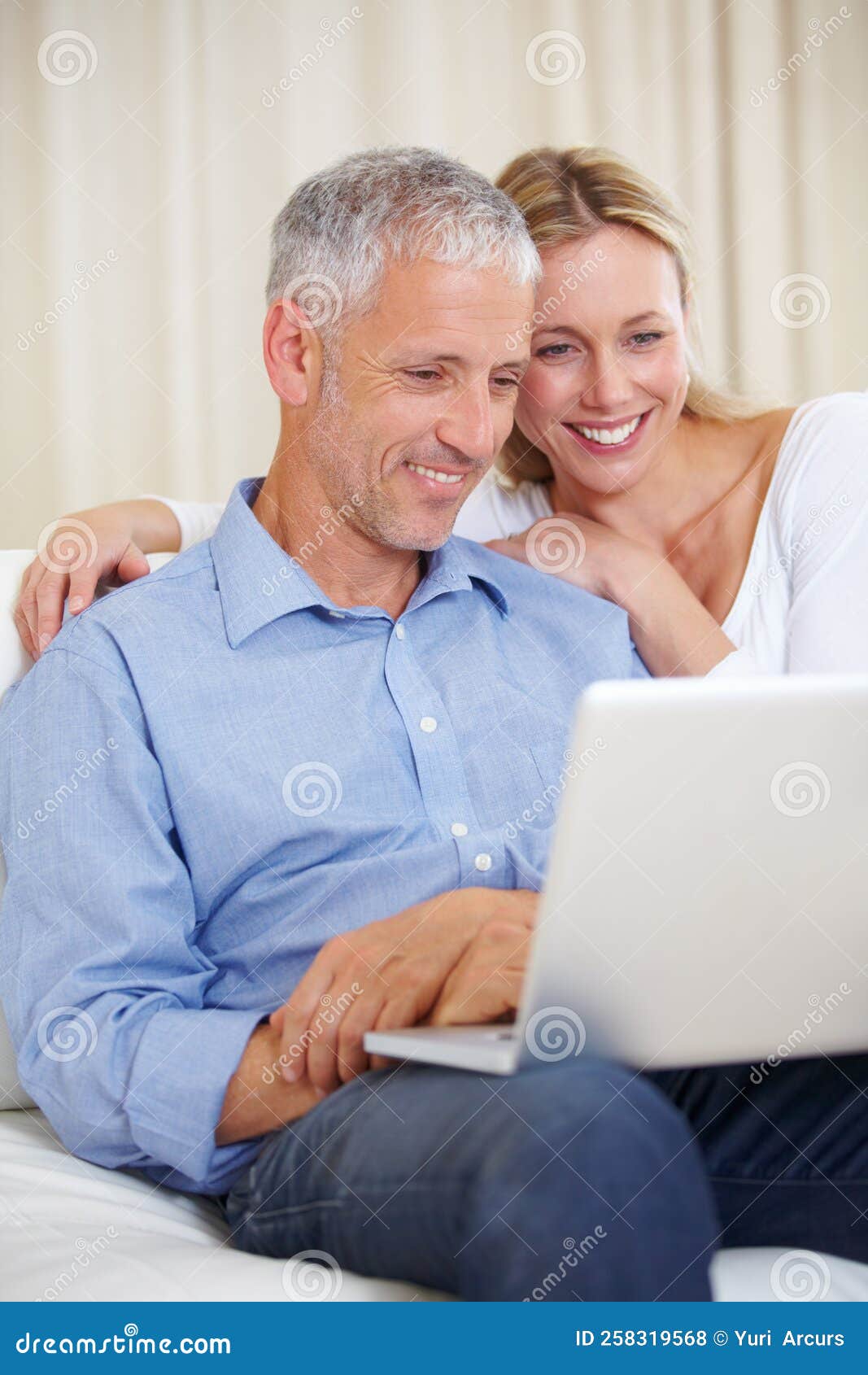 Using the Internet To Plan Their Day. a Married Couple Looking Happy As ...