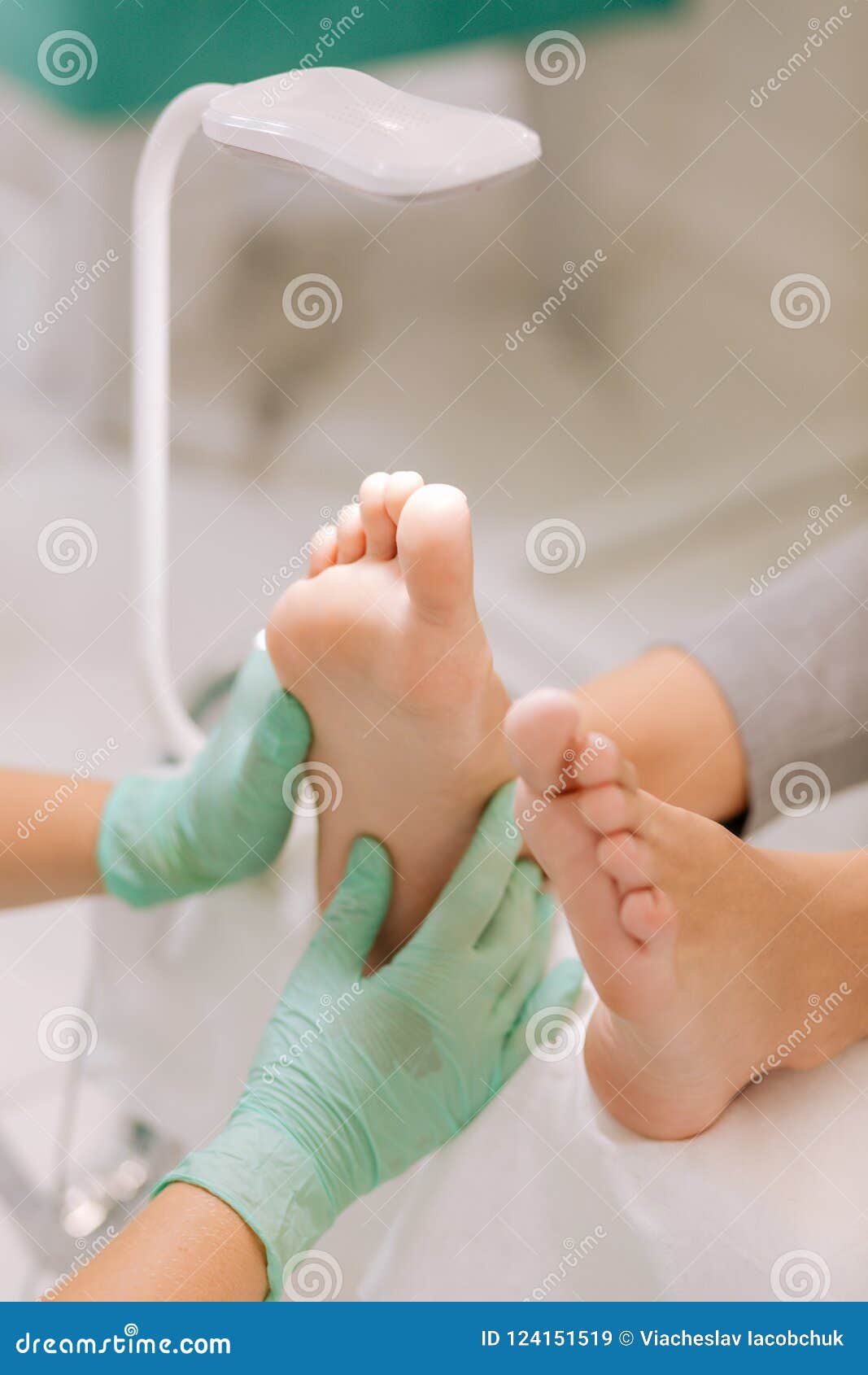 Chiropodist Using Lamp while Practicing Acupressure for Woman Stock ...