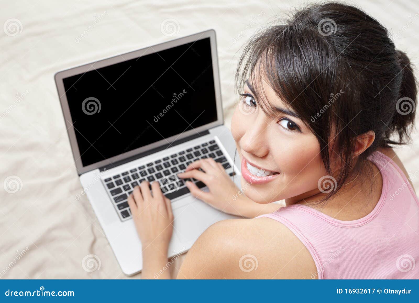 Using laptop on bed stock image. Image of smiling, female - 16932617