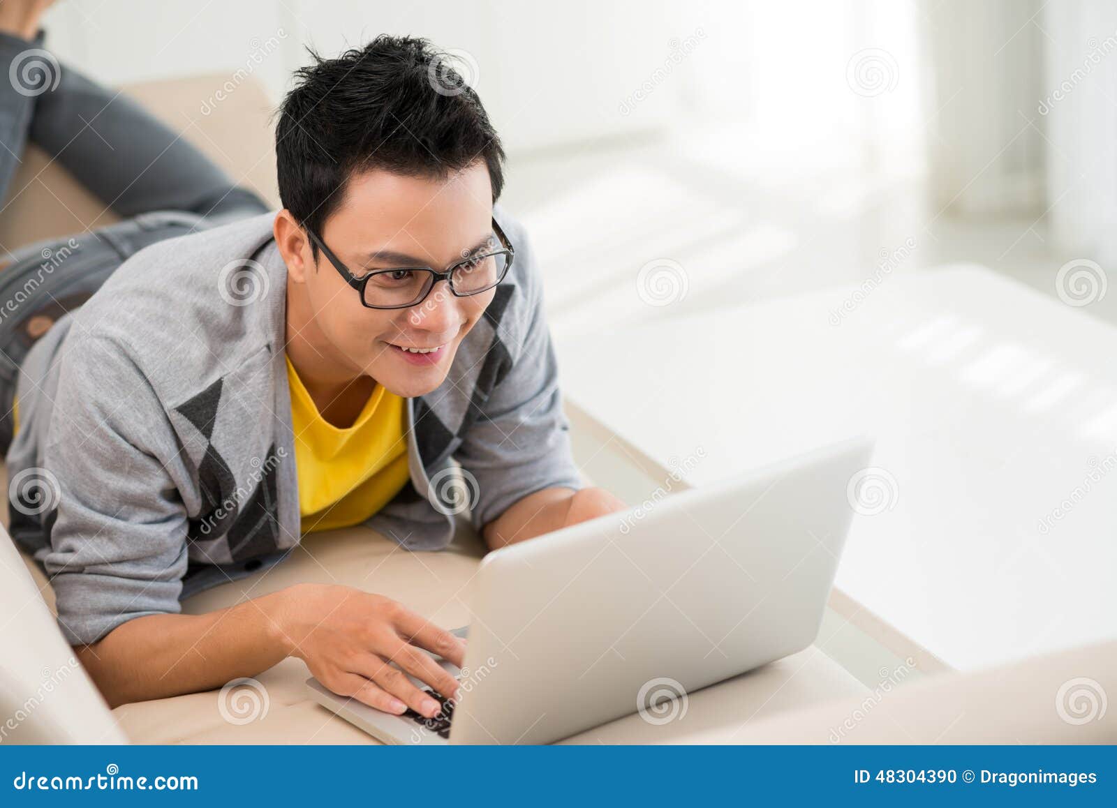 Using laptop at home stock photo. Image of game, browsing - 48304390