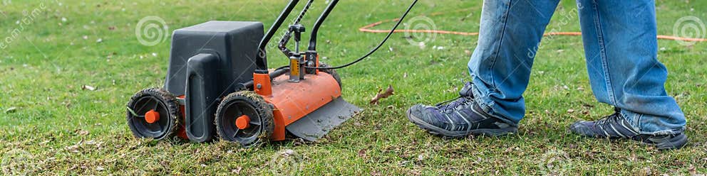 Using a lawn thatcher stock photo. Image of banner, mineral - 176378964