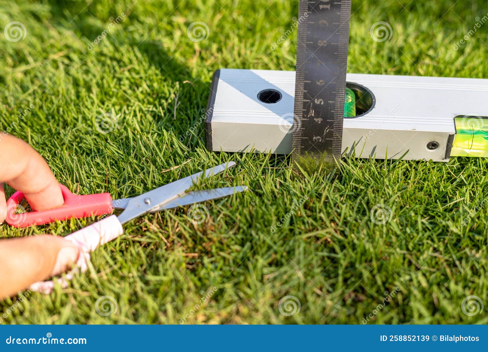 Using Level Tool and Ruler To Cut the Grass Perfectly Stock Image ...