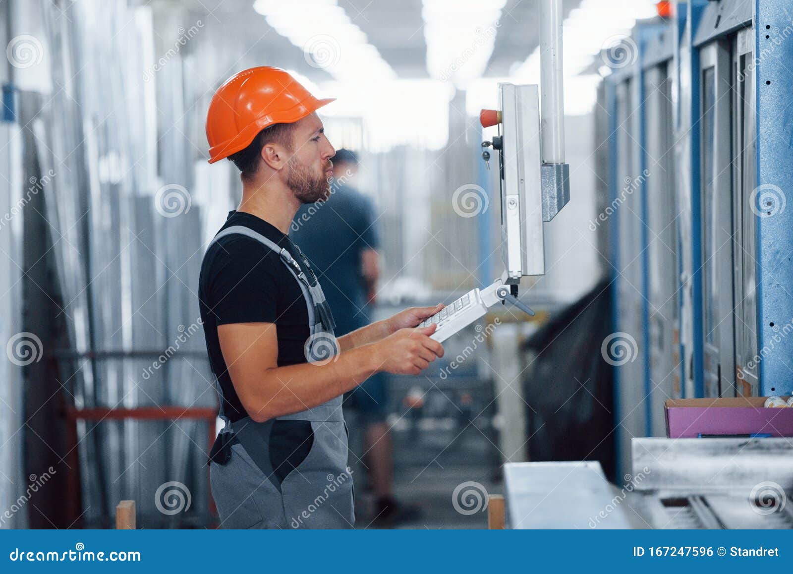 Using Machine To Program Operations. Industrial Worker Indoors in ...