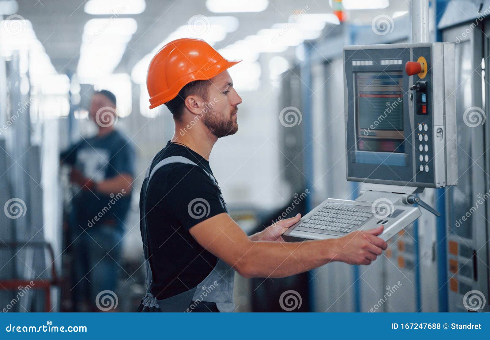 Using Machine To Program Operations. Industrial Worker Indoors in ...