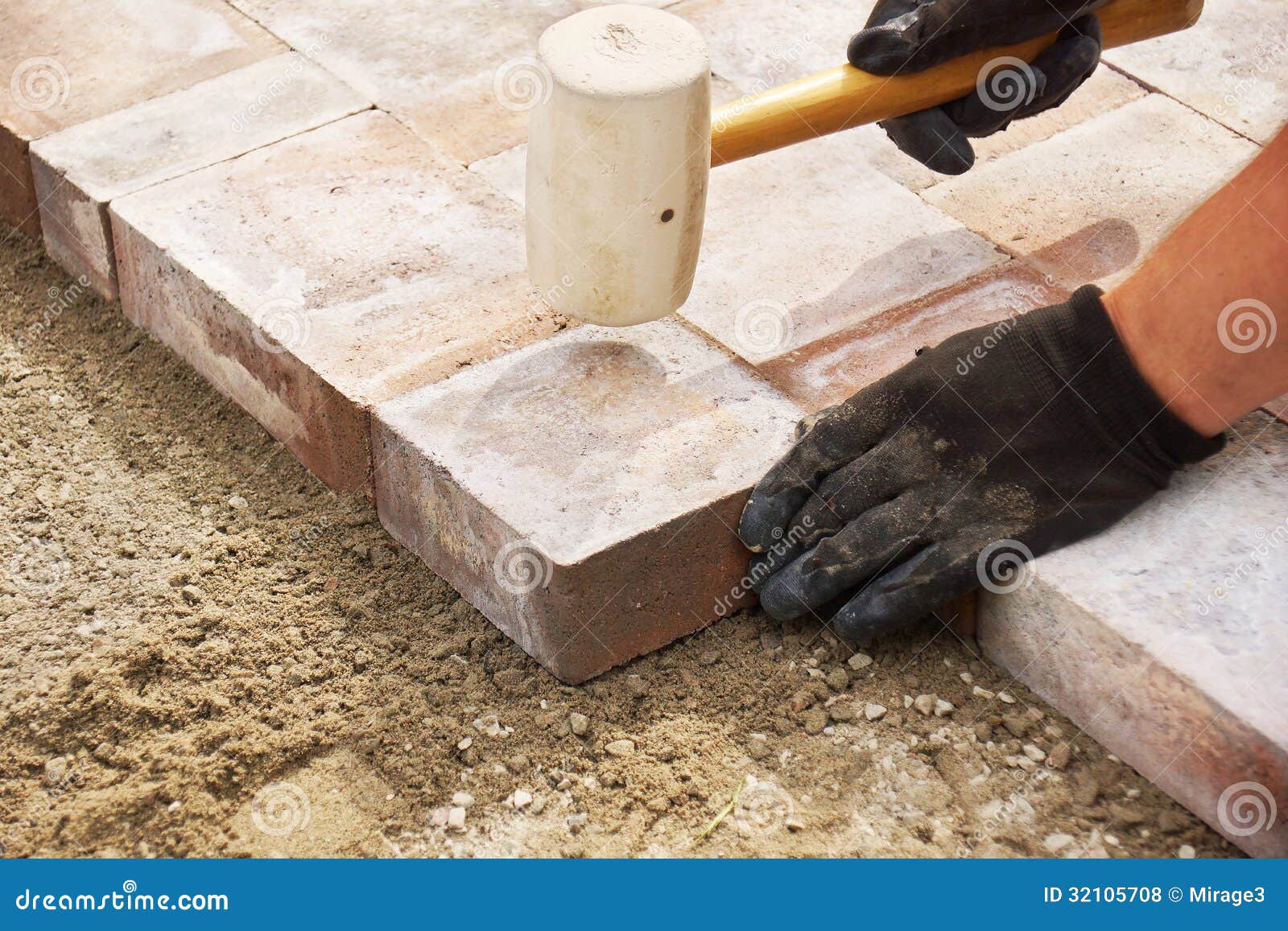 Using a Mallet To Set Paver Stock Photo - Image of paving, material ...