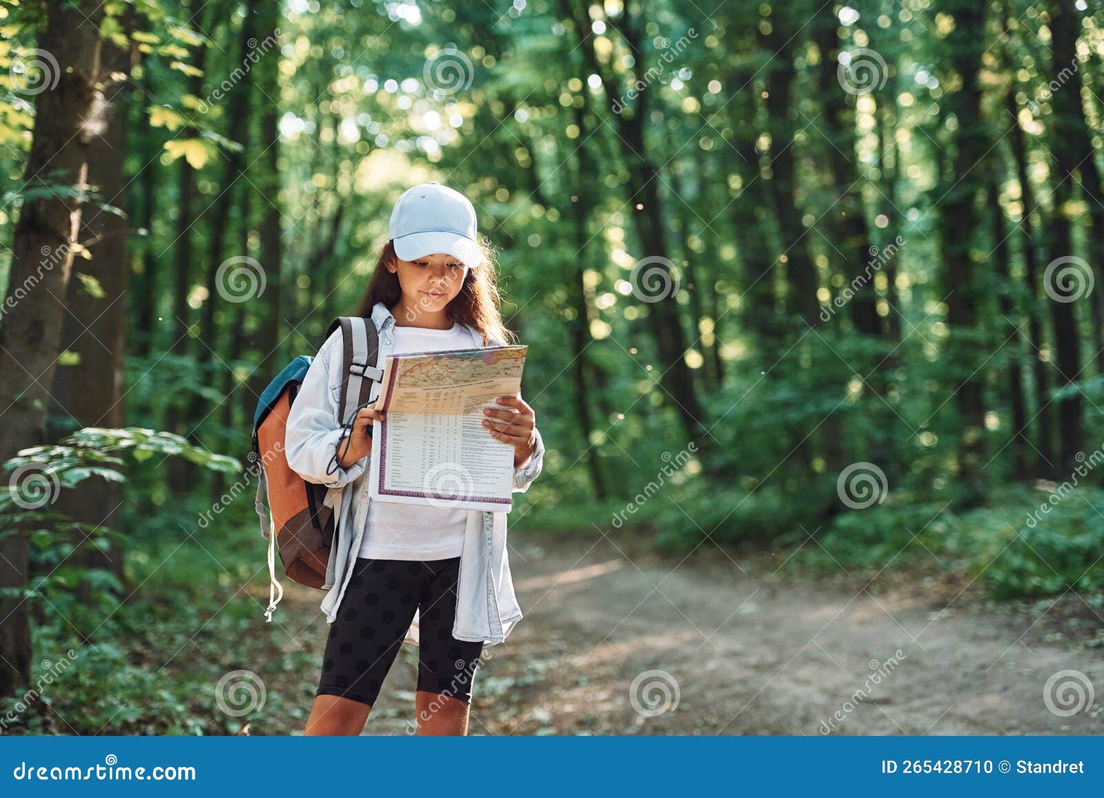 Using the Map. Girl is in the Forest at Summer Day Time Discovering New ...