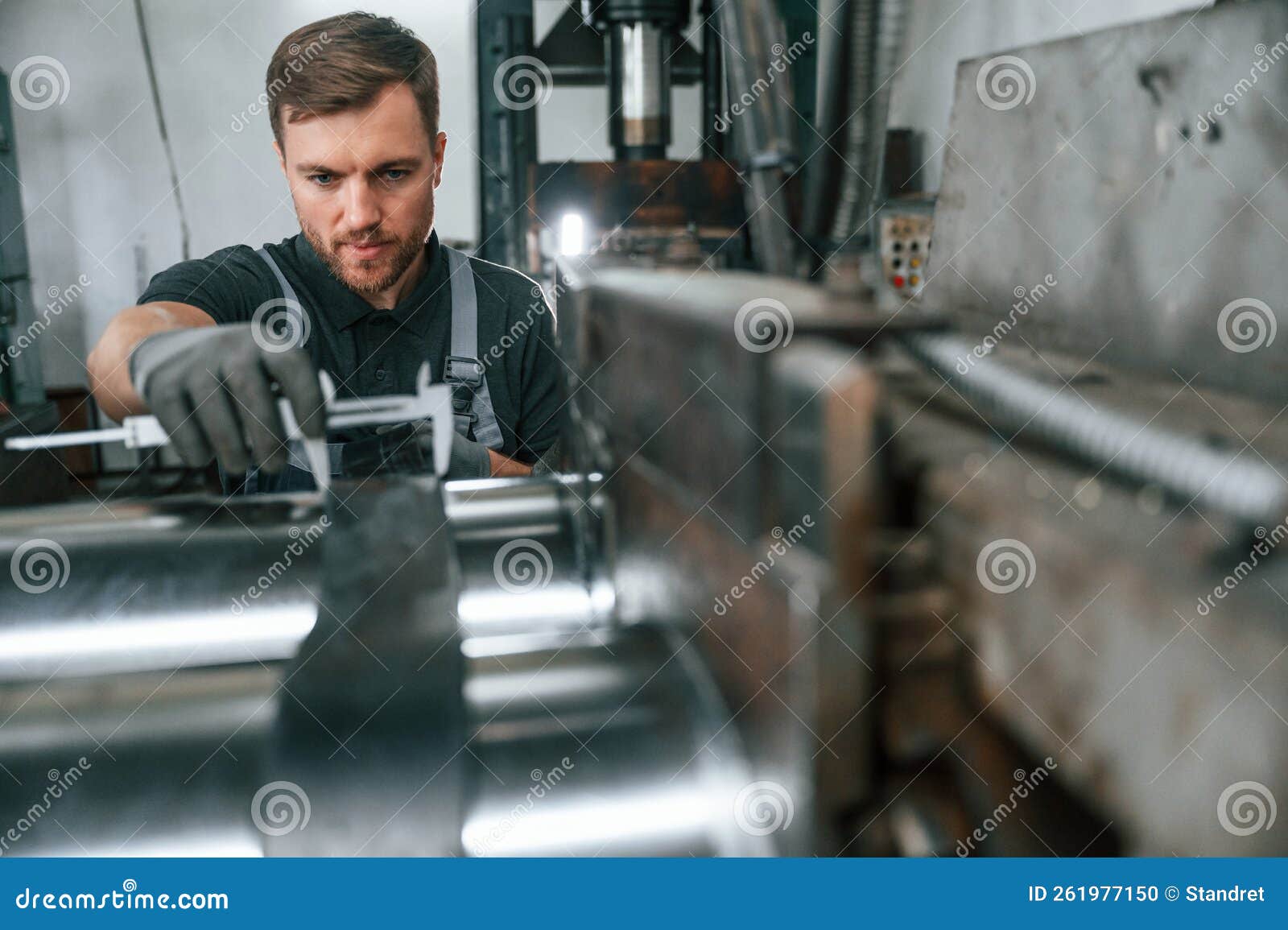 Using Measure Tool. Man in Uniform is in Workstation Developing Details ...