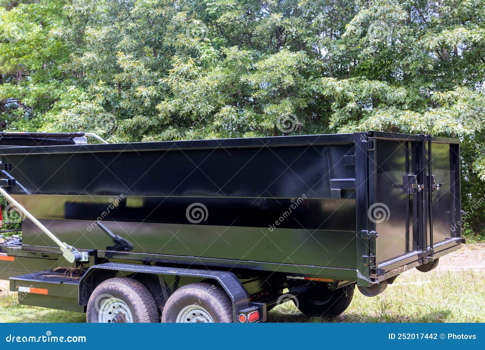 Using a Metal Container Trash Dumpster for Recycling Garbage is ...