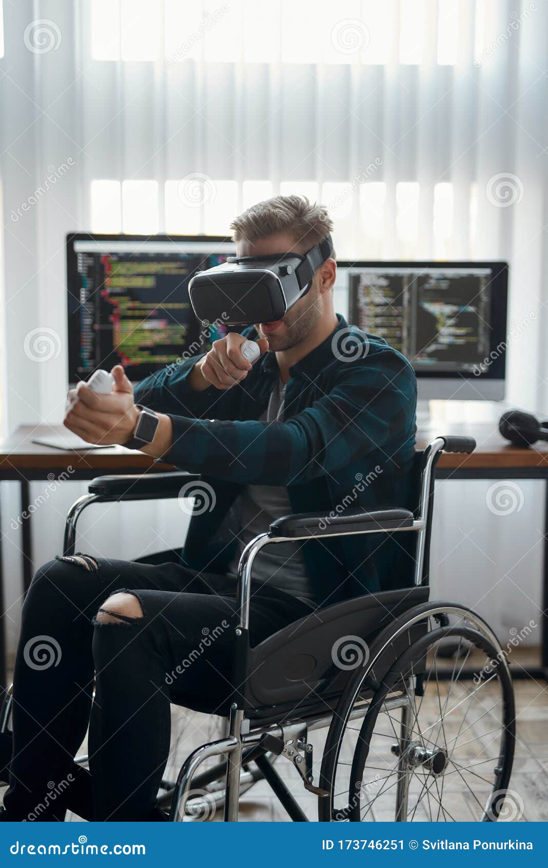 Using Modern Technologies. Young Male Web Developer in a Wheelchair Wearing Virtual Reality ...