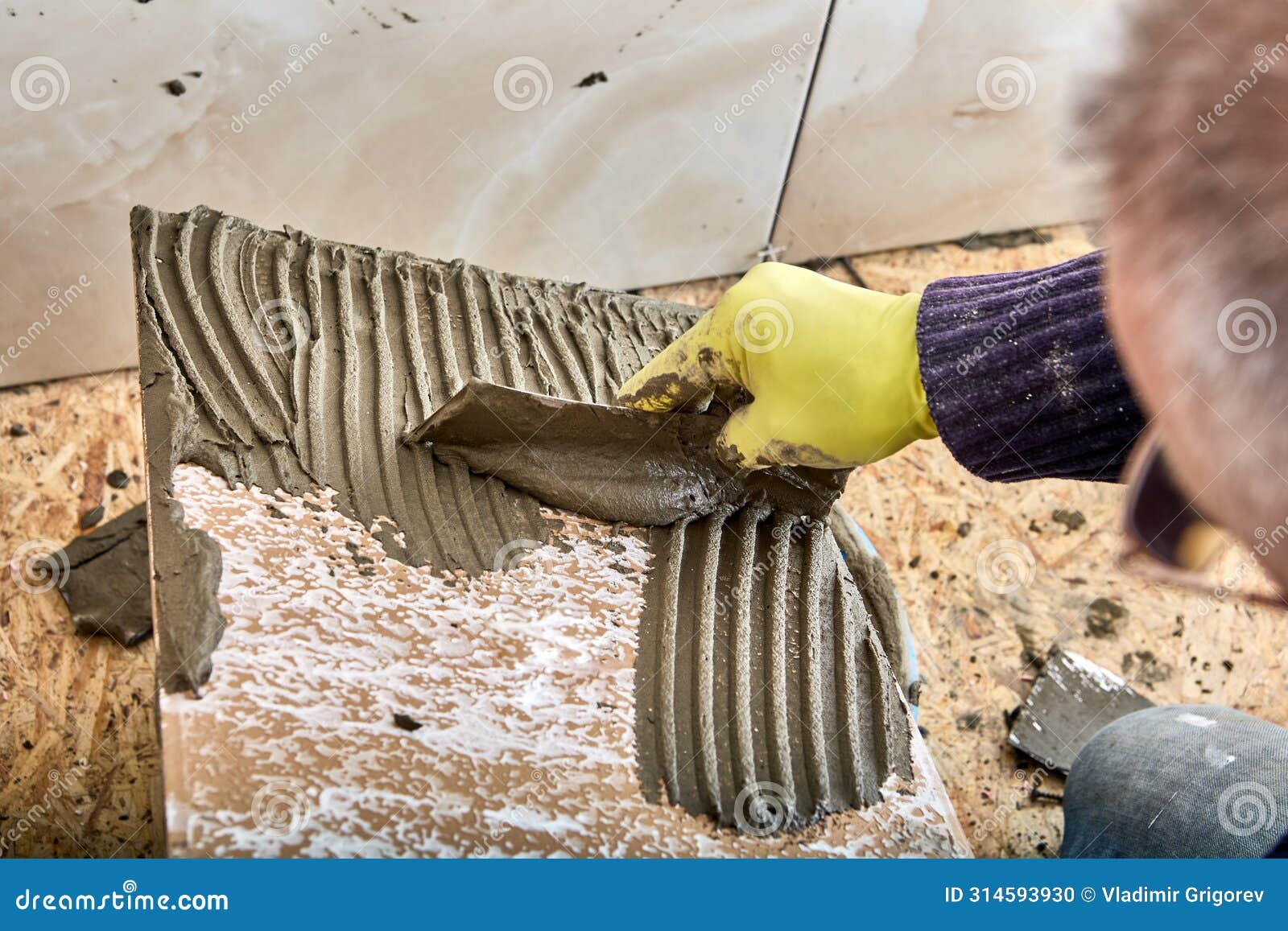 Using Notched Trowel To Apply Cement Mortar Tile Adhesive To Tiles ...