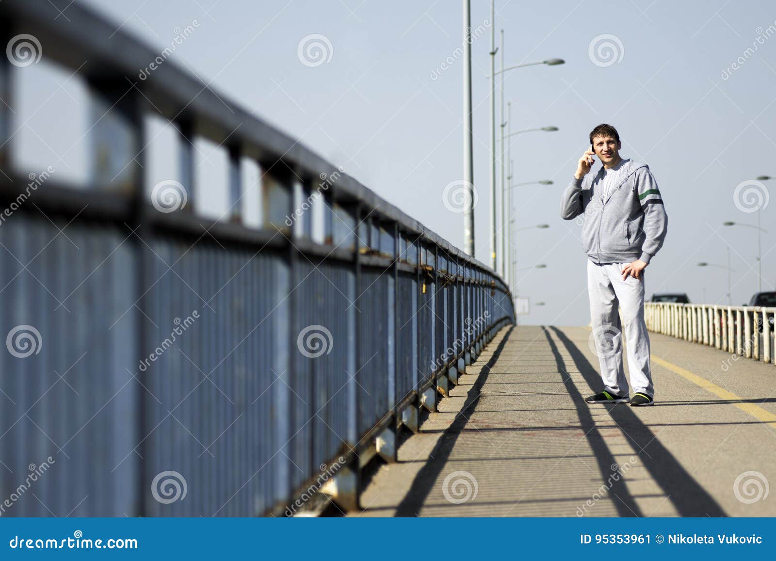 Using phone on bridge stock image. Image of standing - 95353961