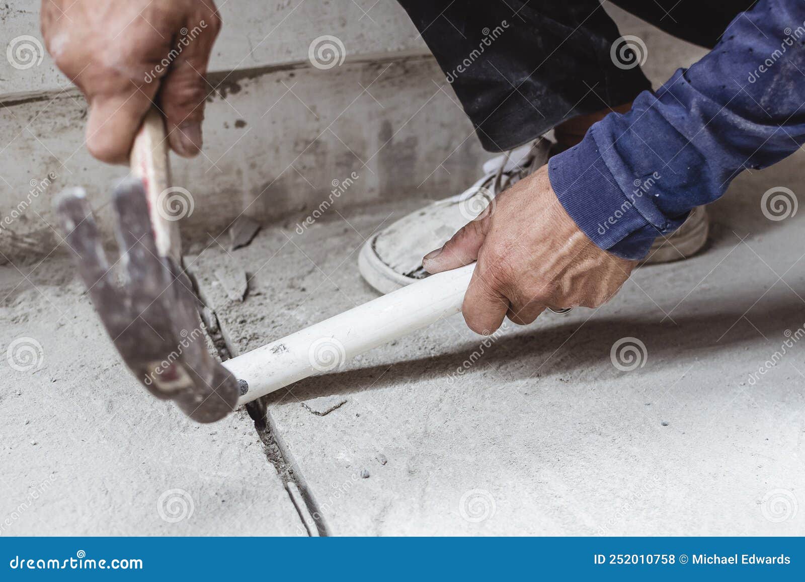 Using a Pipe with an Embedded Nail and a Hammer To Score the Concrete ...