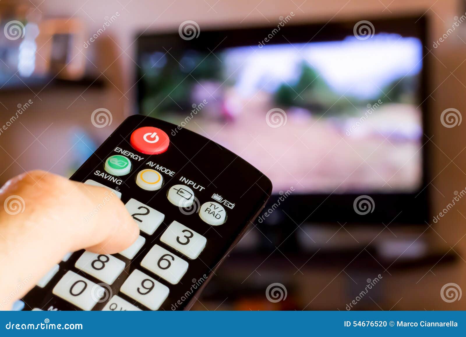 Using the Remote Control To Change Channesl on Tv Stock Photo - Image ...