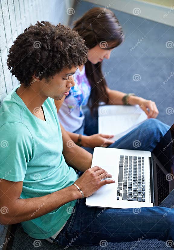 Using Research Resources. Two Young Students Doing Research on a Laptop ...