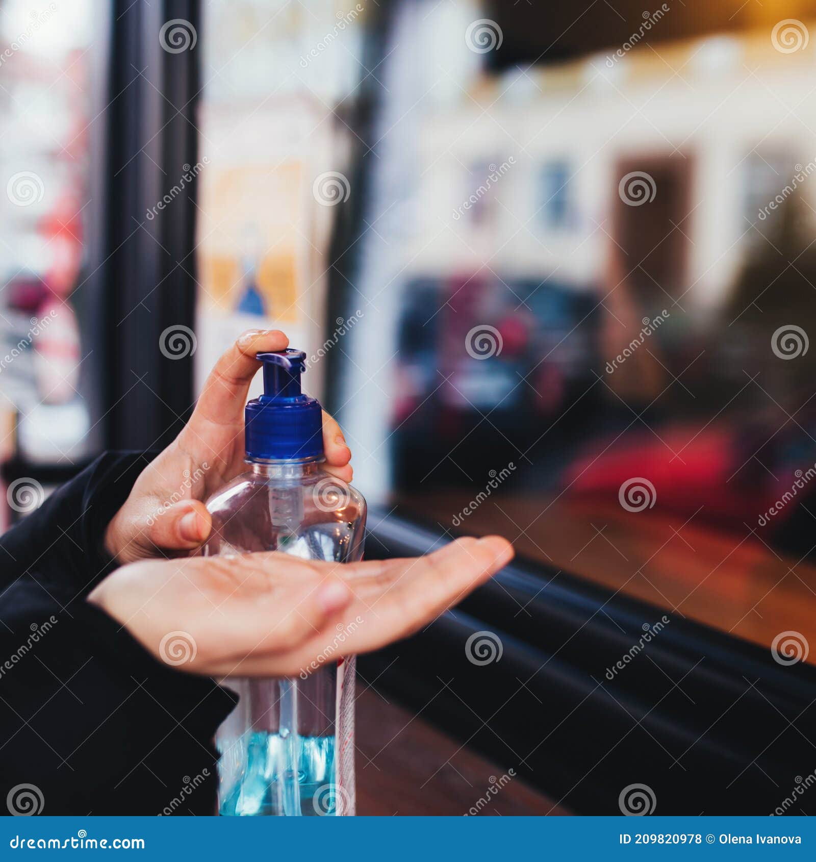 Using of Sanitizer before Entering the Cafe. Blurred Background Stock ...