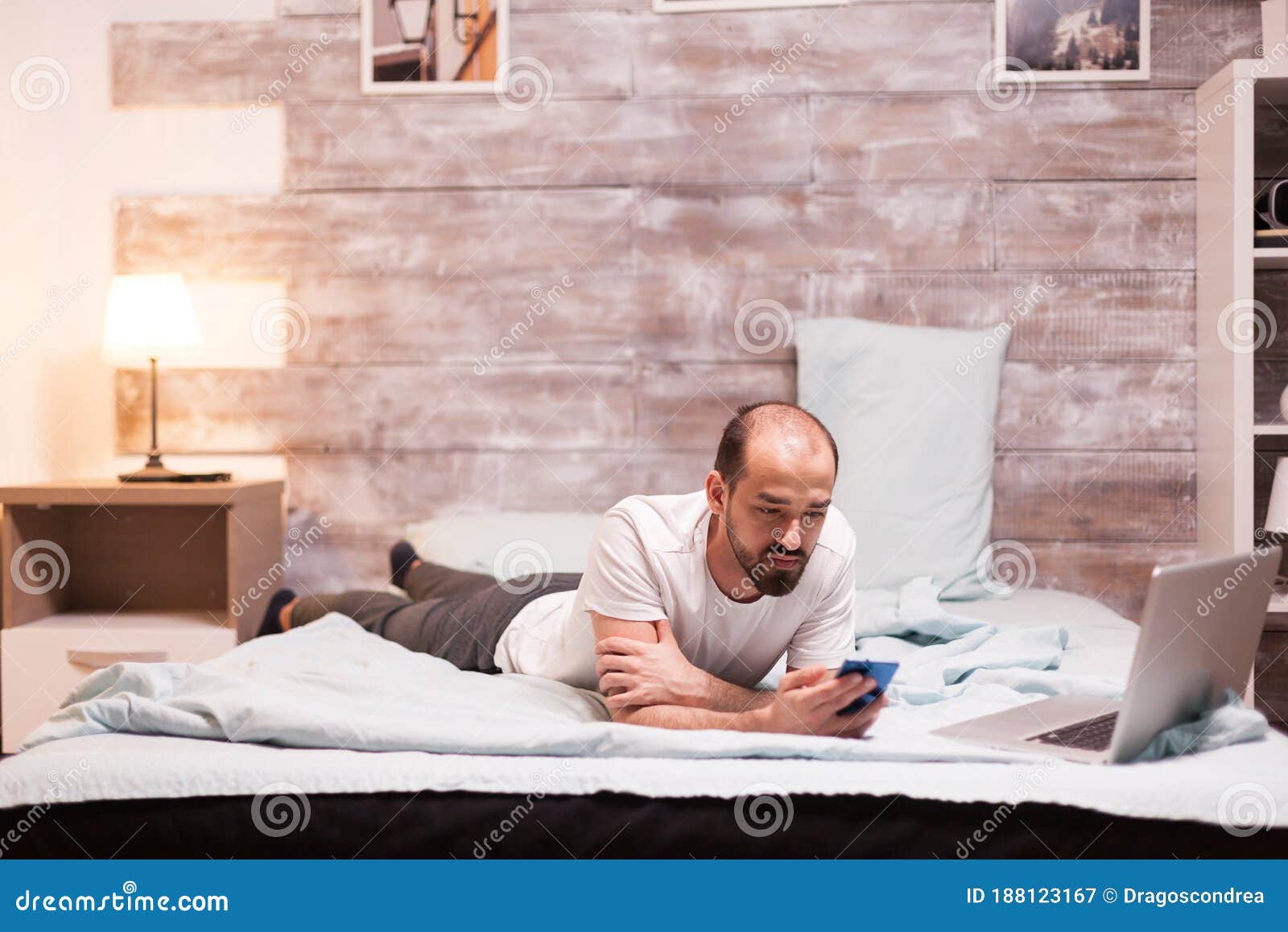 Using Smartphone while Laying on Bed Stock Image - Image of attractive ...