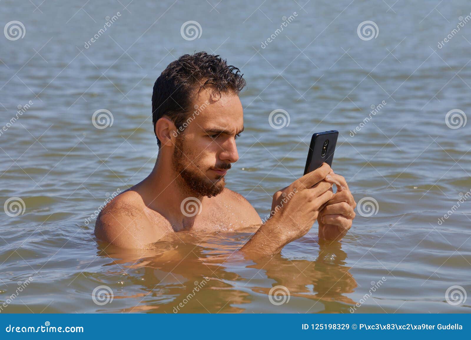 Smartphone at the beach stock image. Image of addiction - 125198329
