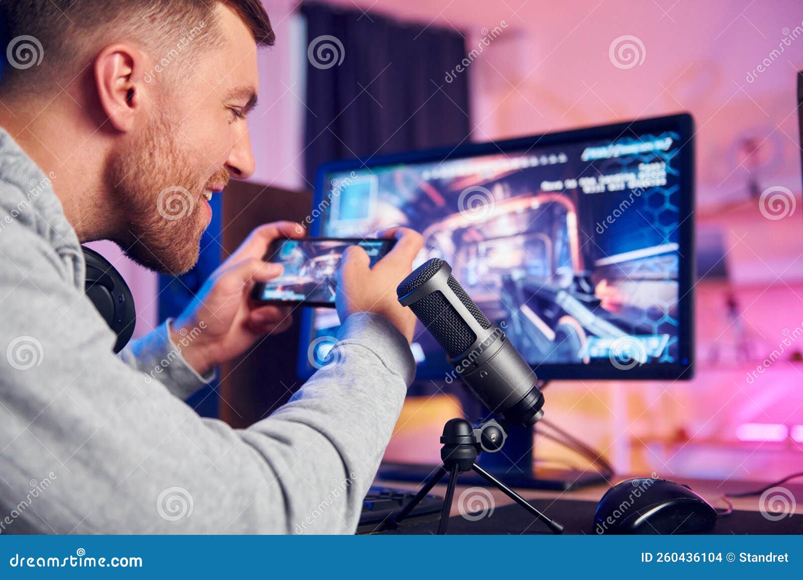 Using the Smartphone. Online Streamer Playing FPS Shooter Game at Home ...