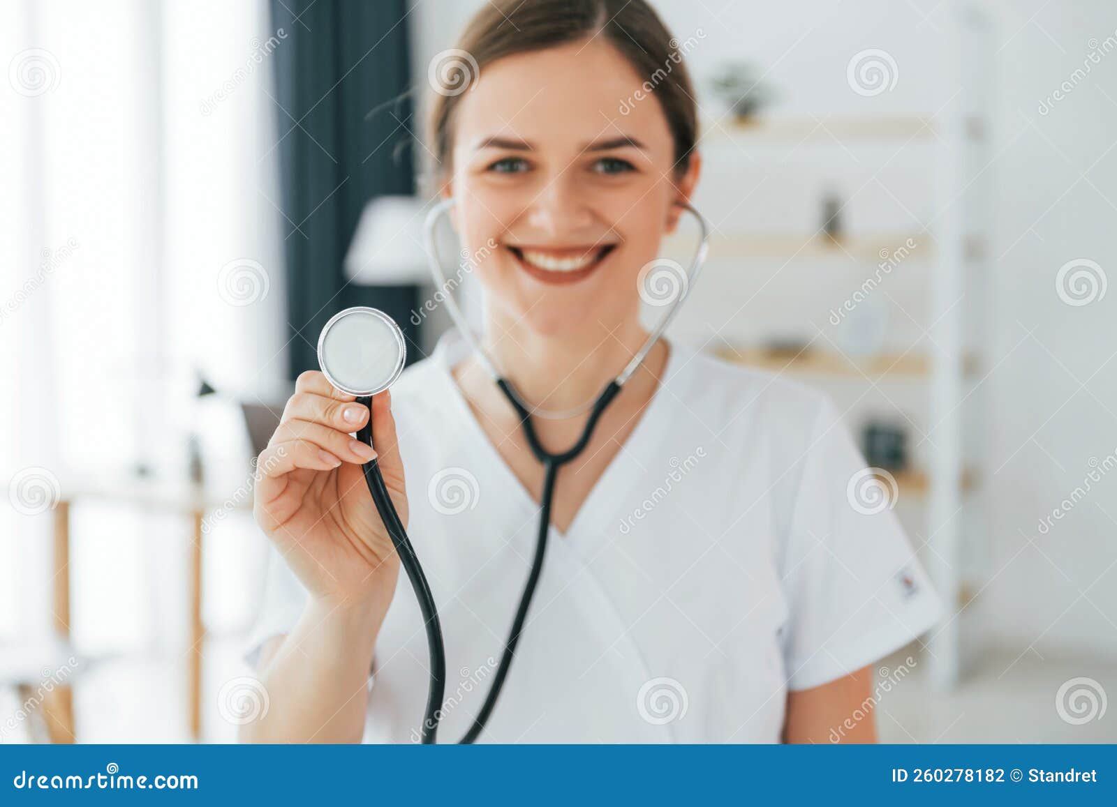 Using Stethoscope. Young Nurse is Standing is in the Office Stock Photo ...