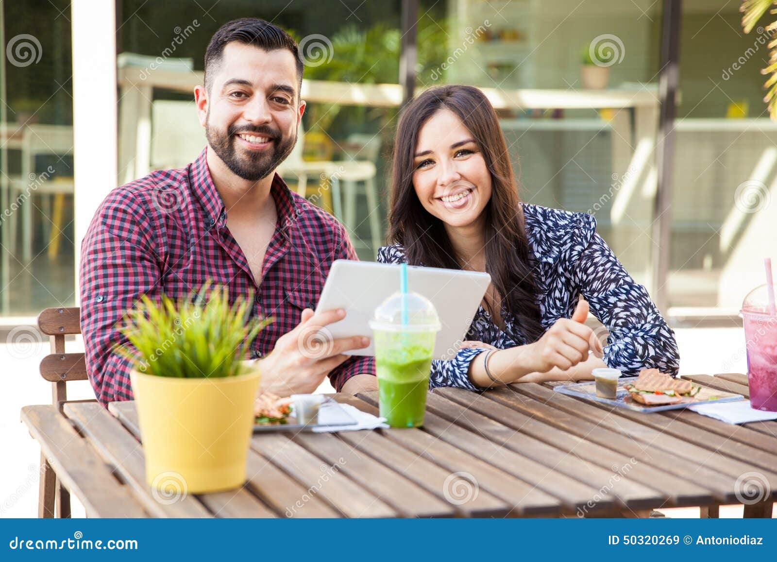 Using a Tablet during Lunch Stock Image - Image of date, cafe: 50320269
