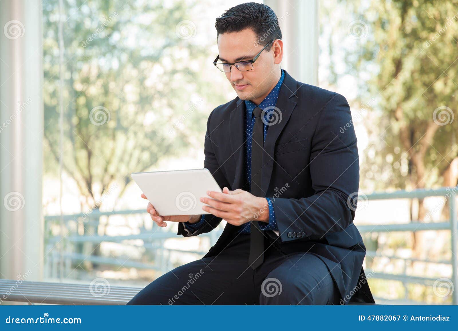 Using a tablet at work stock image. Image of sitting - 47882067