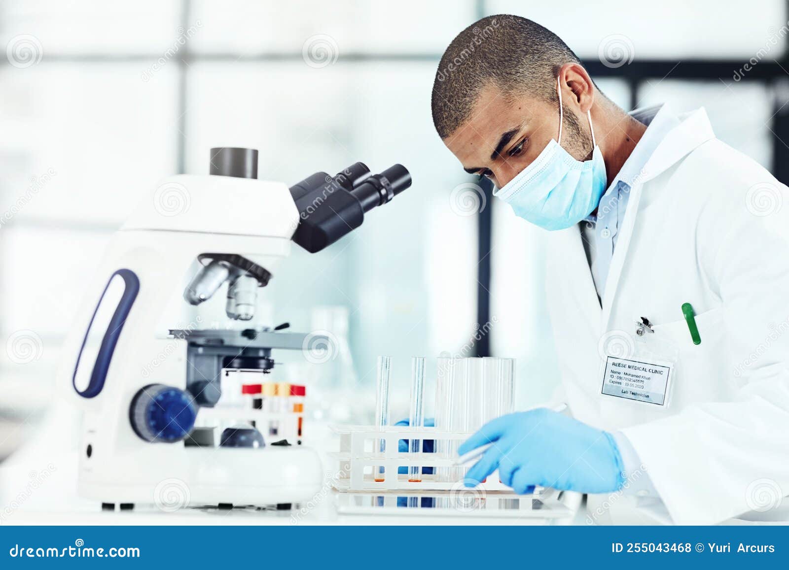Using Technology To Analyse His Blood Sample. a Young Male Scientist ...