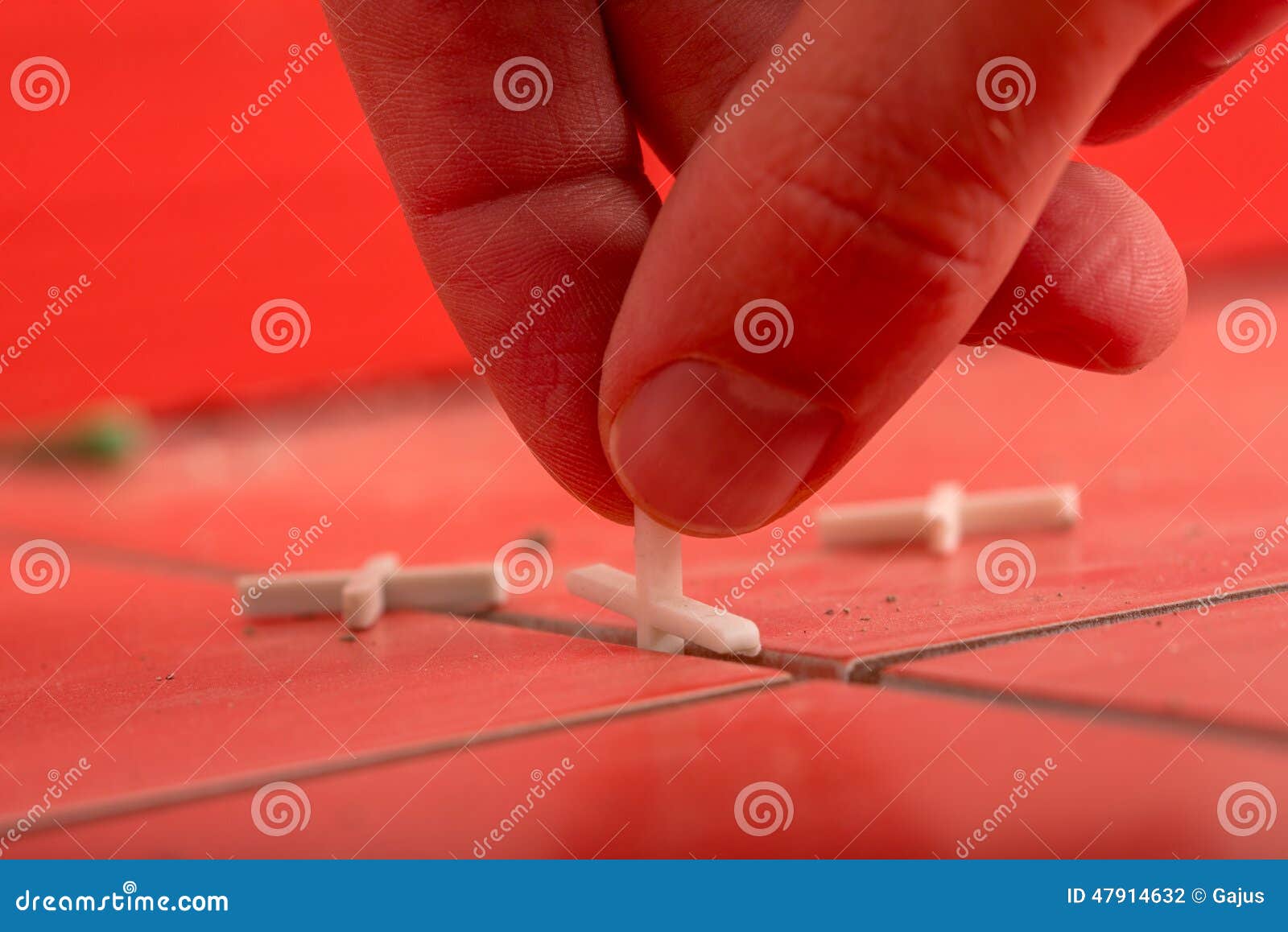 Using Tile Spacers on Red Tiles Stock Photo - Image of grouting ...