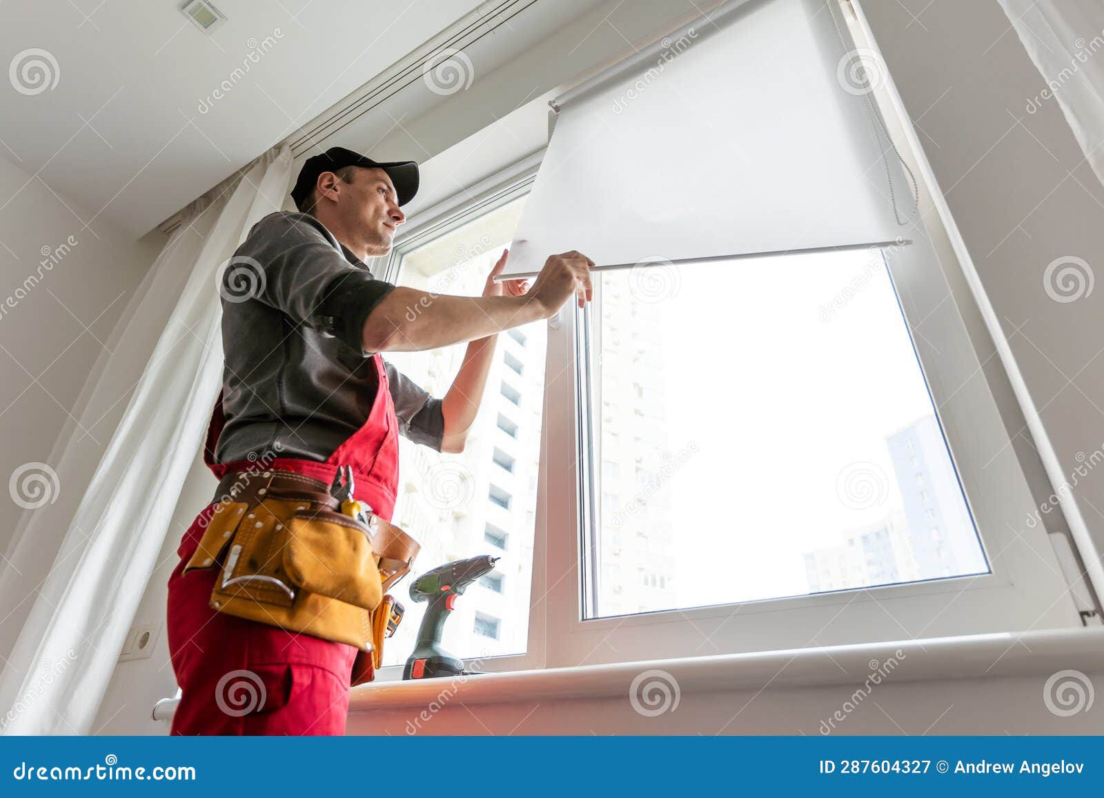 Using Tool on the Windows. Repairman is Working Indoors in the Modern ...