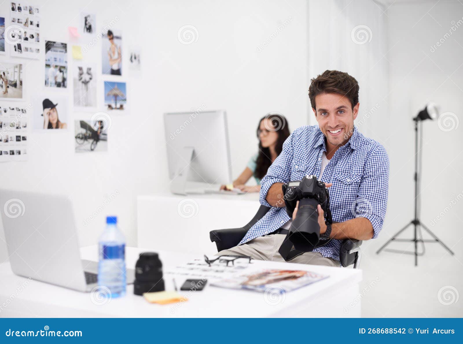 Using the Tools of the Trade. Two Photographers Sitting in Their Office ...