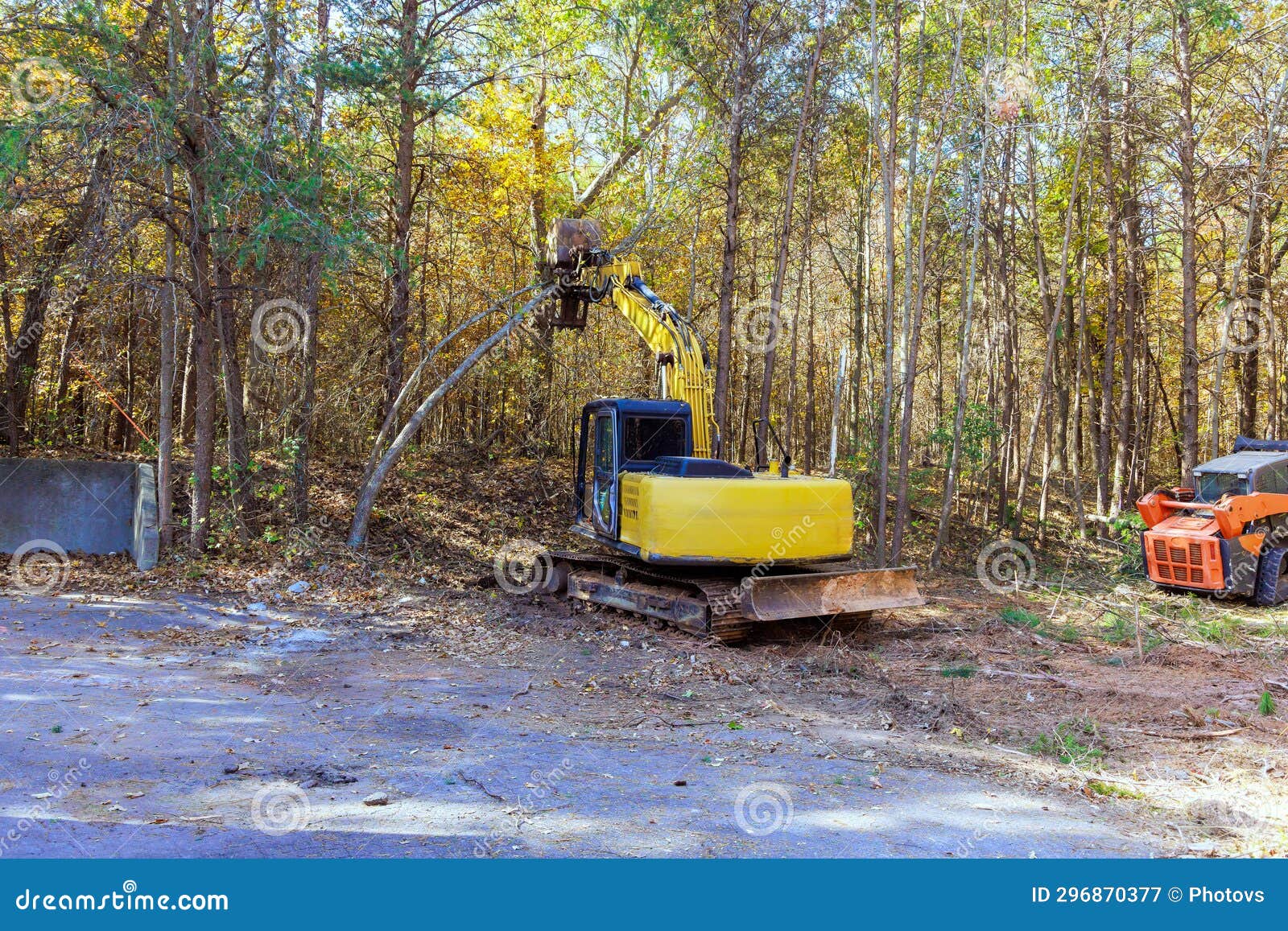 Using a Tractor Builder Uproots Trees in Forest Preparation for ...