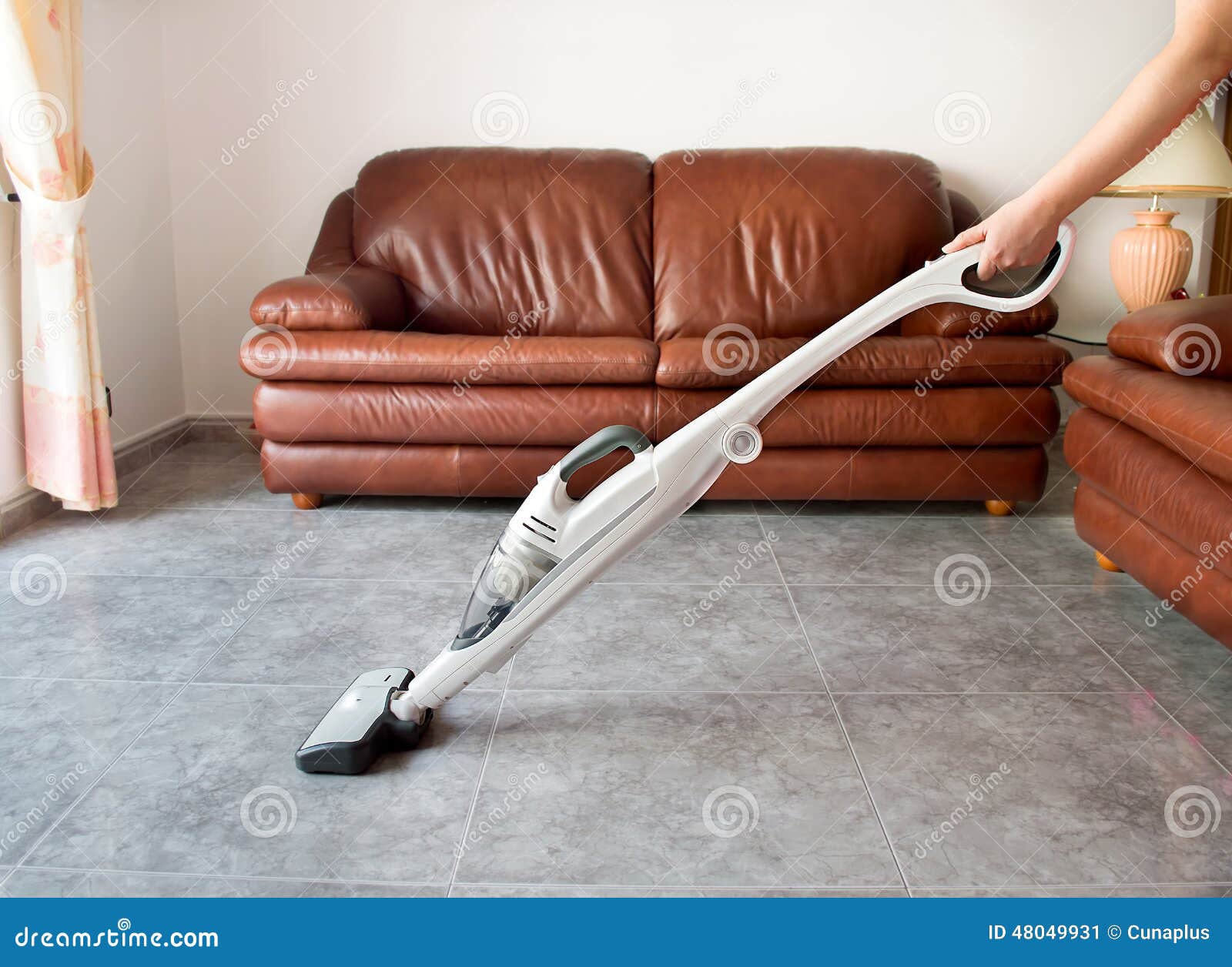 Using the vacuum cleaner stock image. Image of living - 48049931