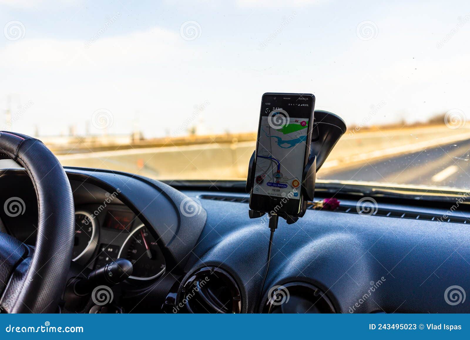 Using Waze Maps Application on Smartphone in Car Dashboard. Driver ...