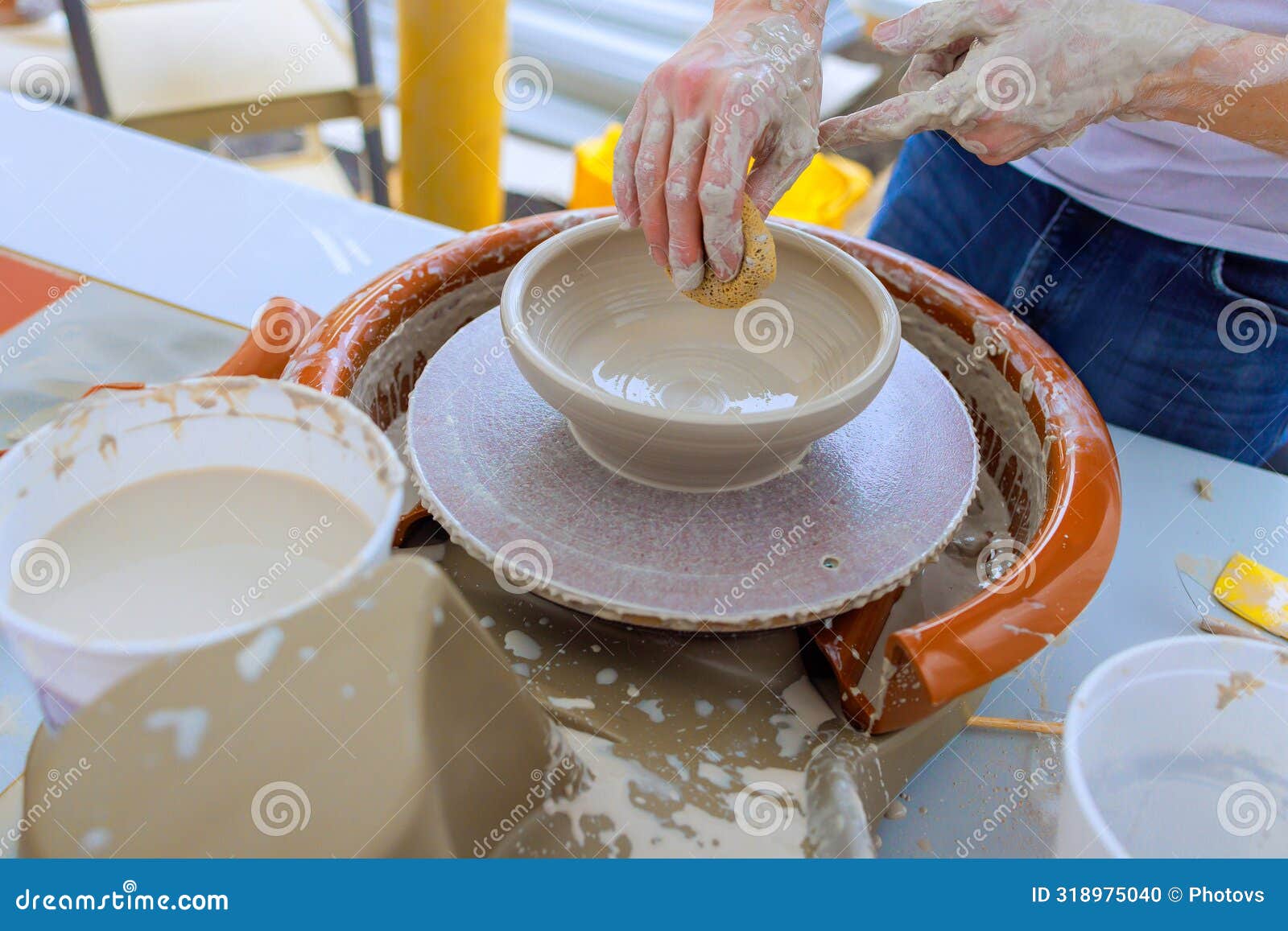 Using Wet Hands, Ceramicist Shapes Soft Clay on a Potter Wheel Stock ...