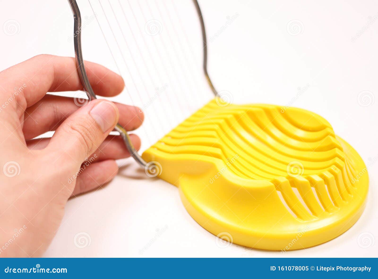 Using Yellow Egg Slicer Cutter Isolated Stock Image - Image of kitchen ...
