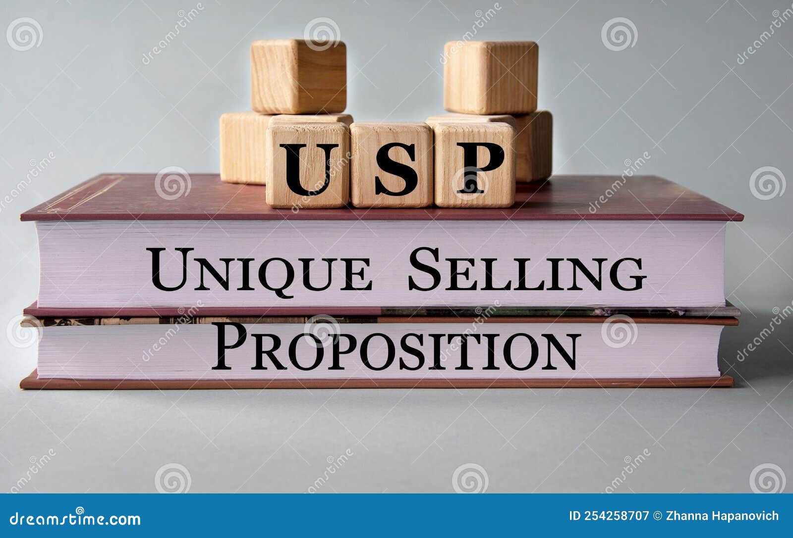 USP - Acronym on Wooden Cubes on the Background of Recumbent Books ... USP - Acronym on Wooden Cubes on the Background of Recumbent Books ...