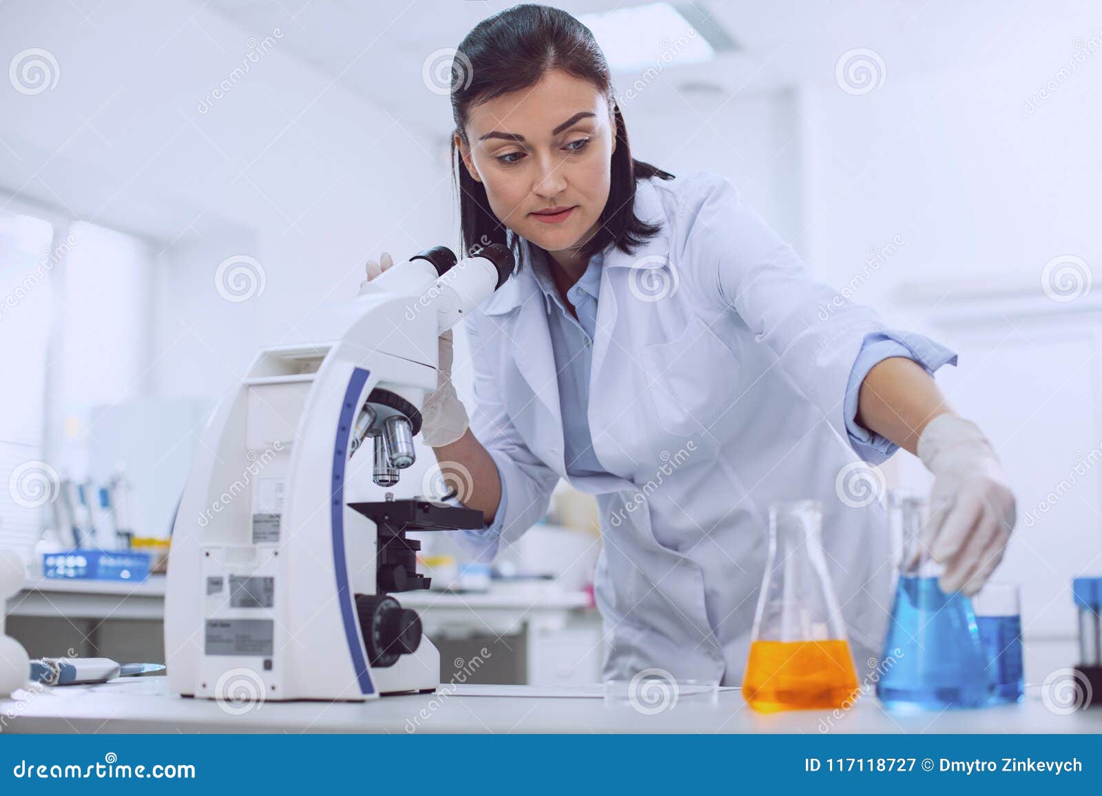 Concentrated Female Biologist Working with a Microscope Stock Image ...